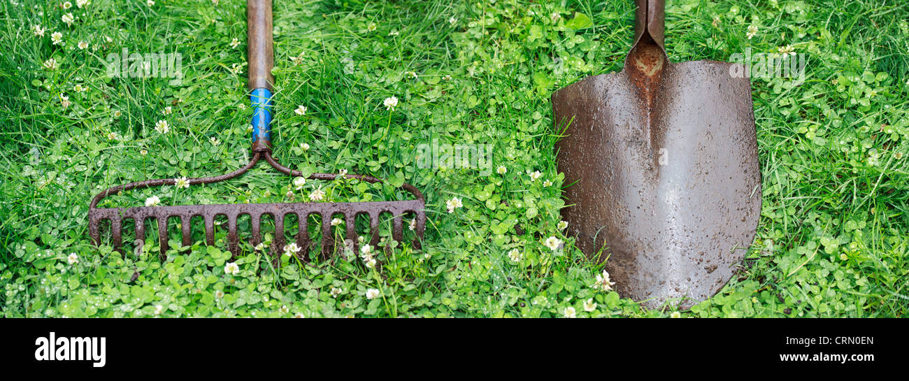 Metal Garden Rake and Shovel on top of Lawn Stock Photo - Alamy