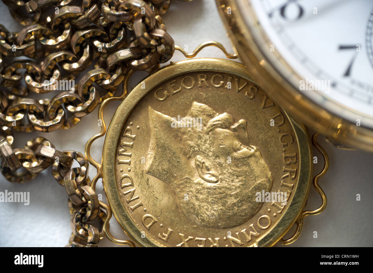 A gold pocket watch with Arabic numerals seconds dial and intricate ...