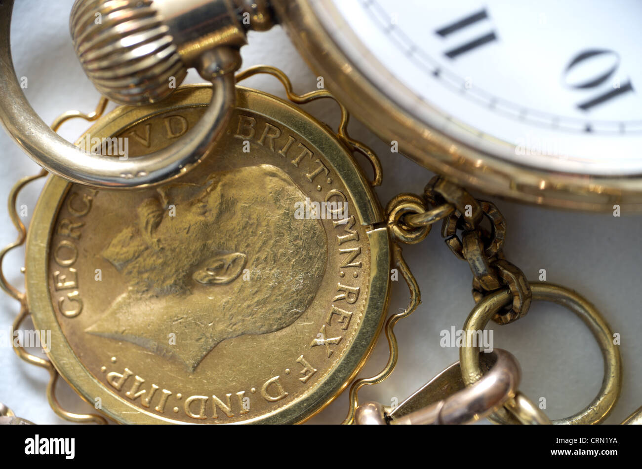 A gold pocket watch with Arabic numerals seconds dial and intricate ...
