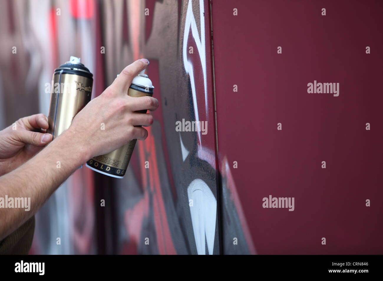 Graffiti Artist hands with paint cans Stock Photo - Alamy
