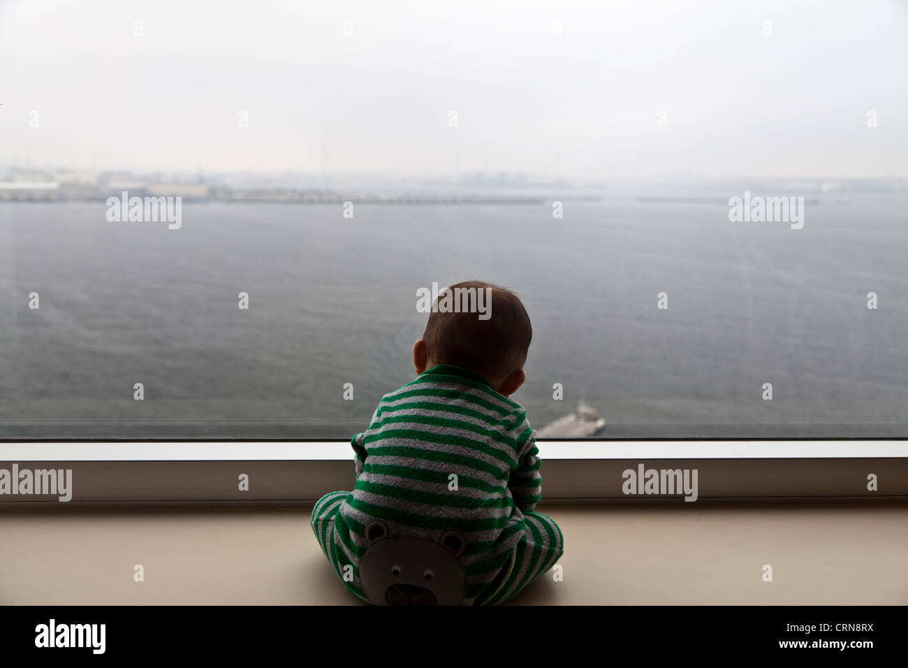 Baby looking out window, Yokohama Harbor Japan Stock Photo - Alamy