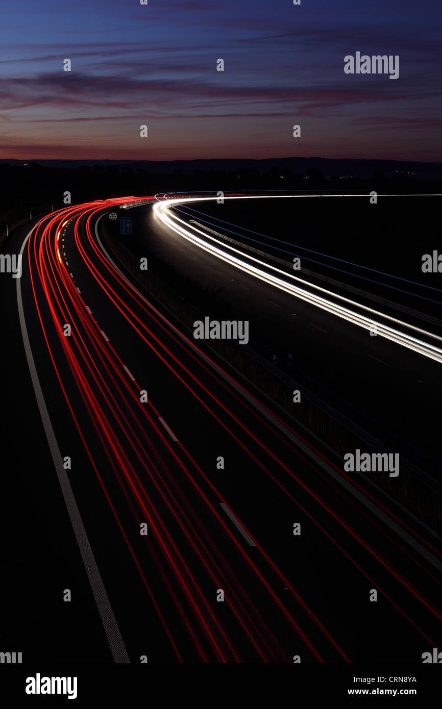 Cars moving fast on a night highway (motion blurred image Stock Photo ...