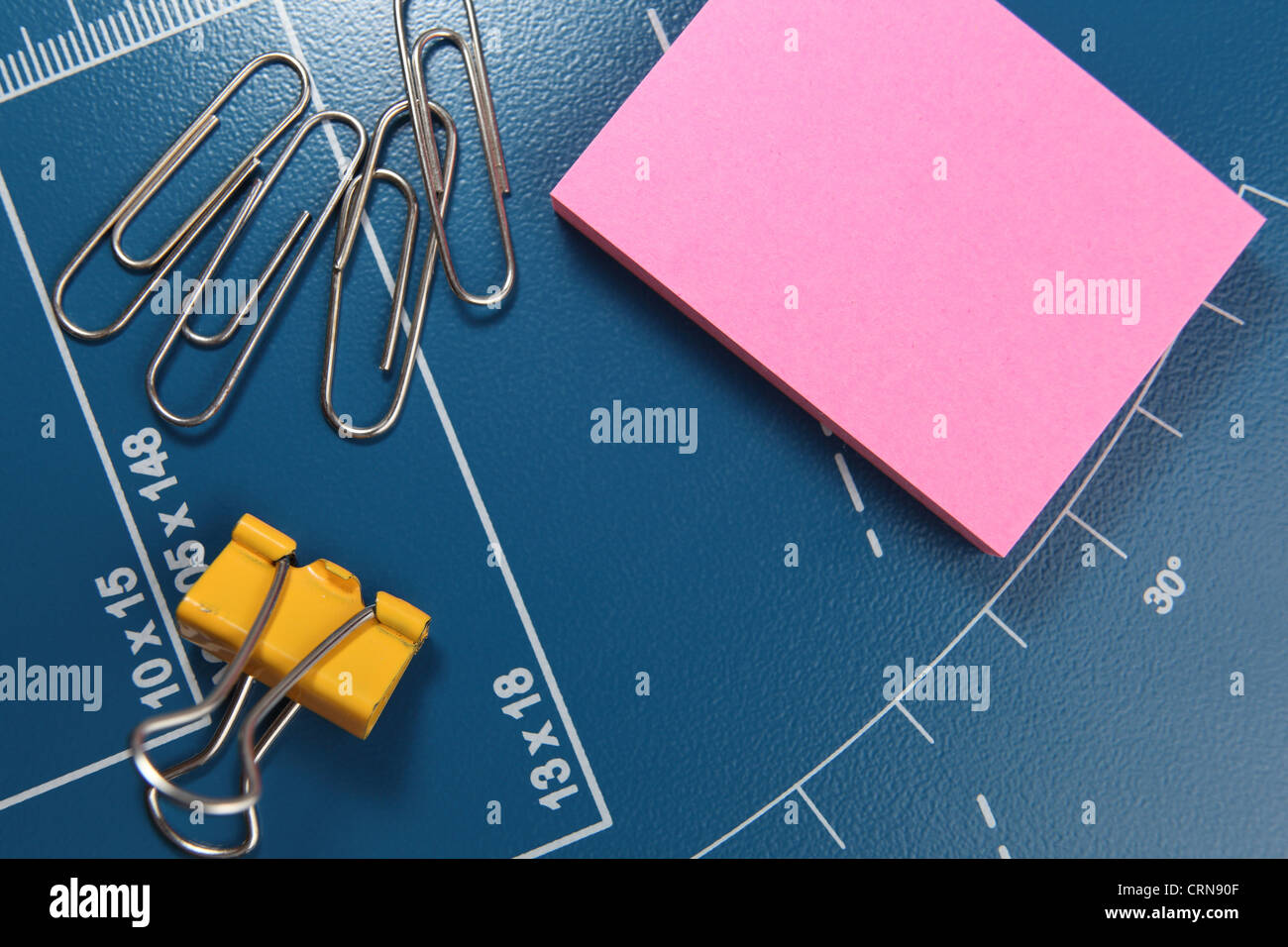 office stationery - paper clips and post-it pink note paper Stock Photo ...