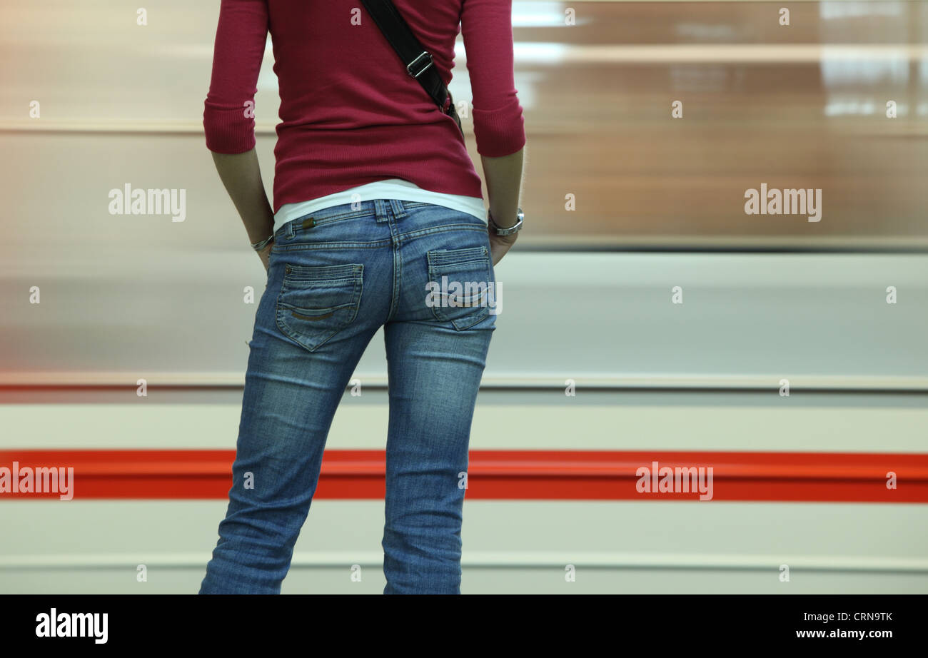 Underground - Young woman waiting for her connection Stock Photo - Alamy