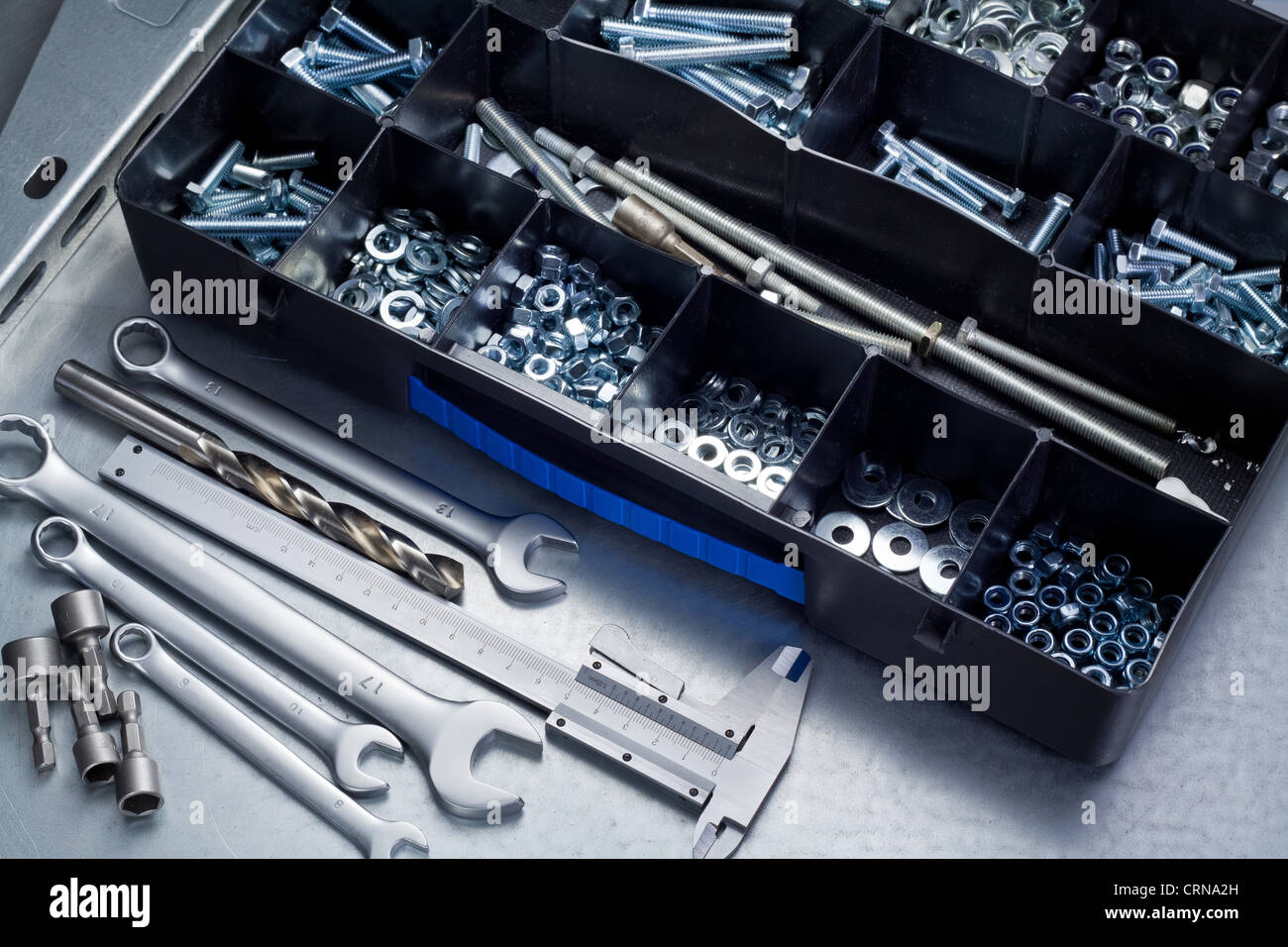 Metal workshop. Plastic toolbox with screws, bolts and some tools Stock ...