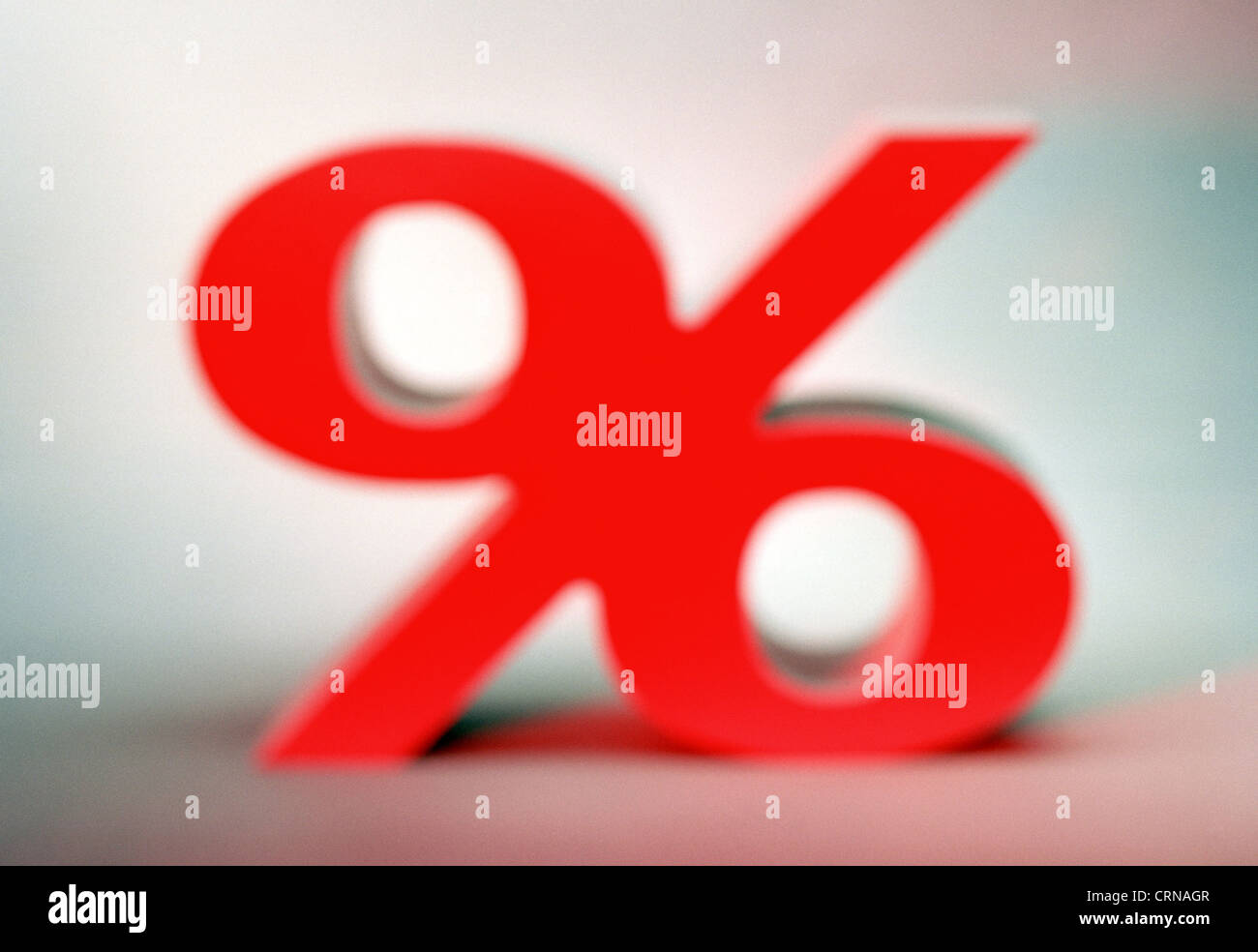 An illuminated red percent sign before a light background Stock Photo ...