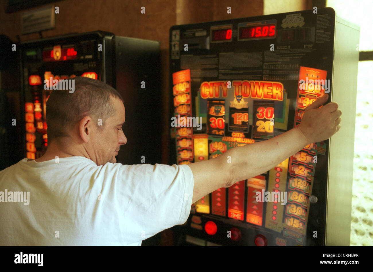 Berlin man playing on a slot machine Stock Photo - Alamy
