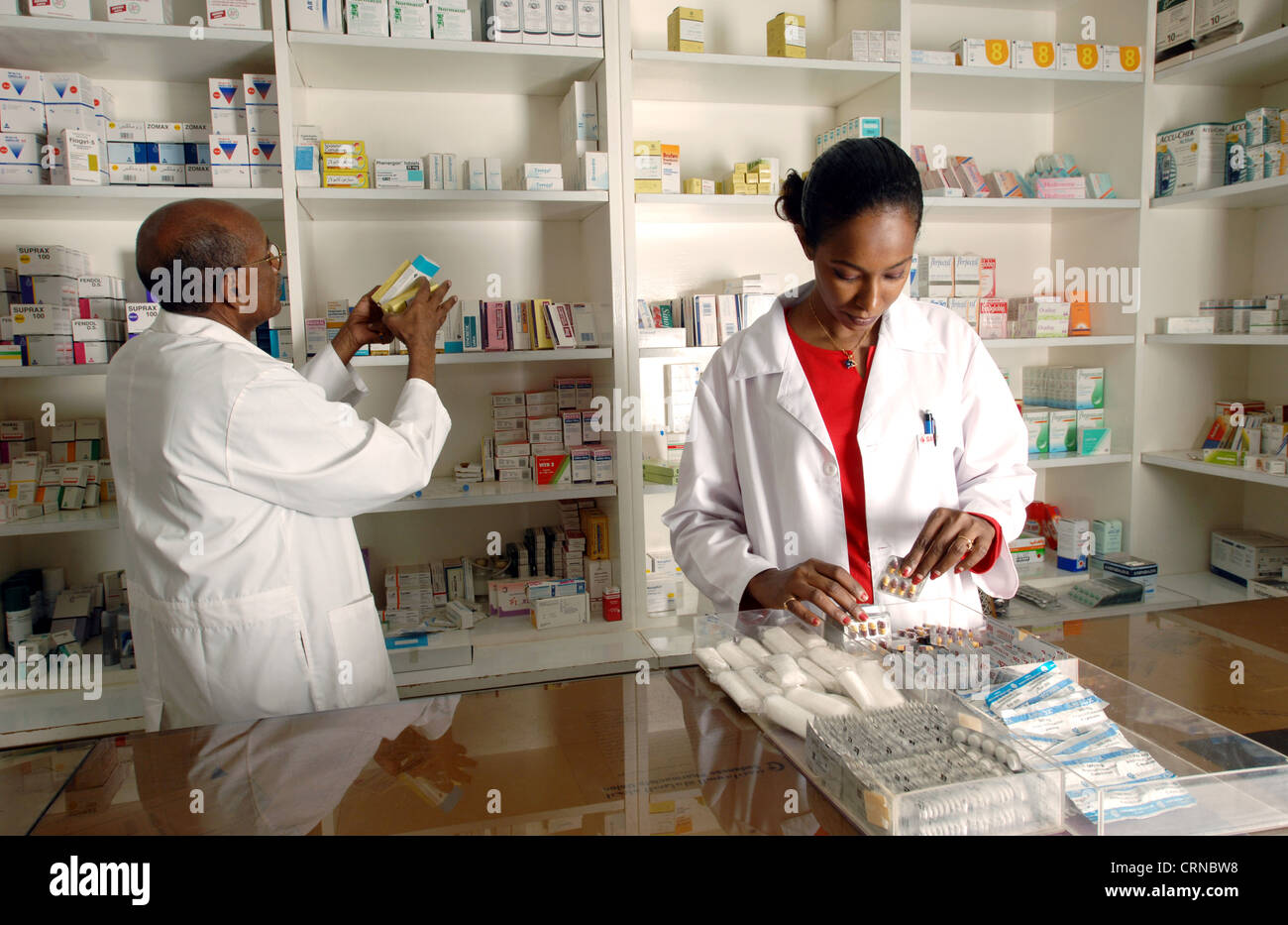 counter at a pharmacy with pharmacists sorting out the pills Stock ...