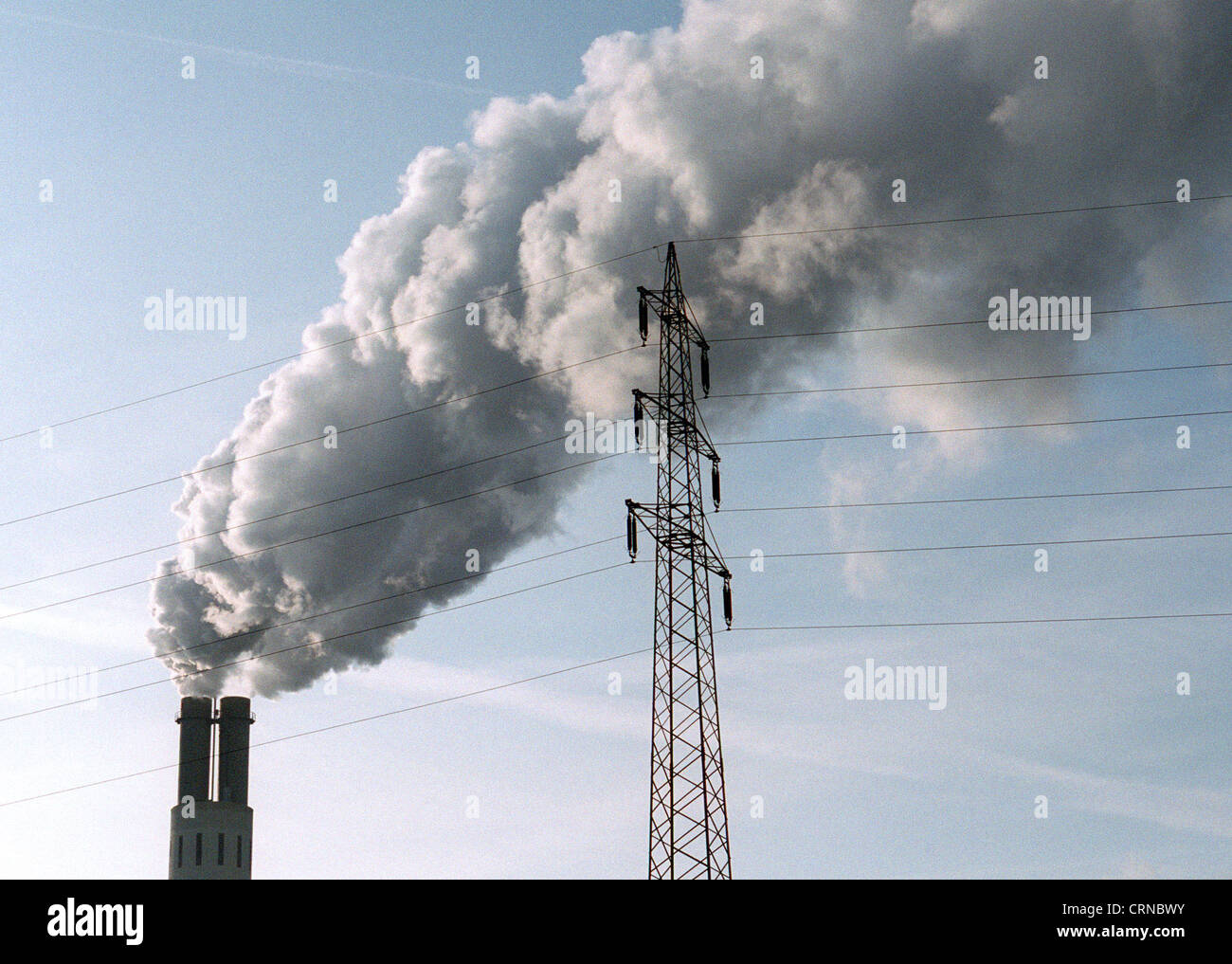 Smoking power station chimney with utility pole Stock Photo - Alamy