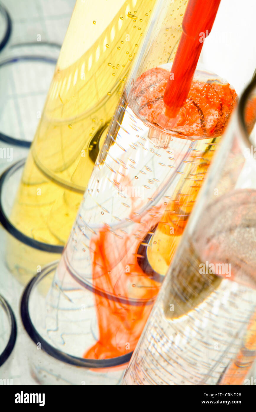 Pipetting red liquid into clear liquid solution hi-res stock ...