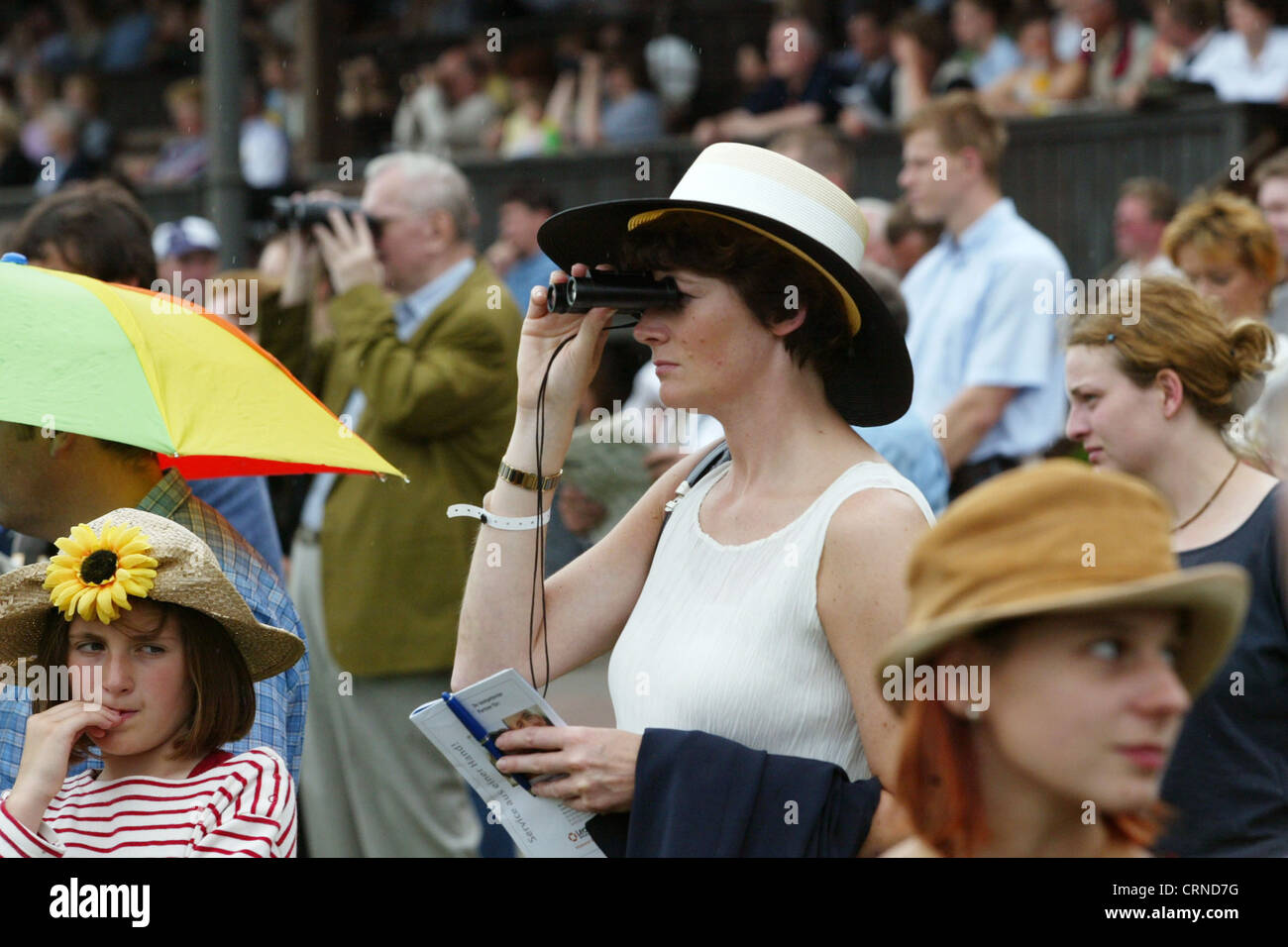 Spectator with binoculars in the audience Stock Photo - Alamy