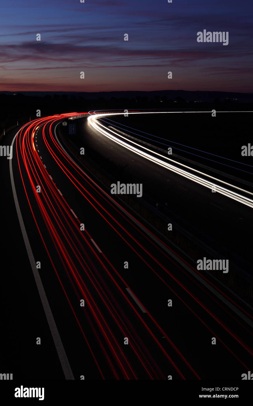 Cars moving fast on a night highway (motion blurred image Stock Photo ...