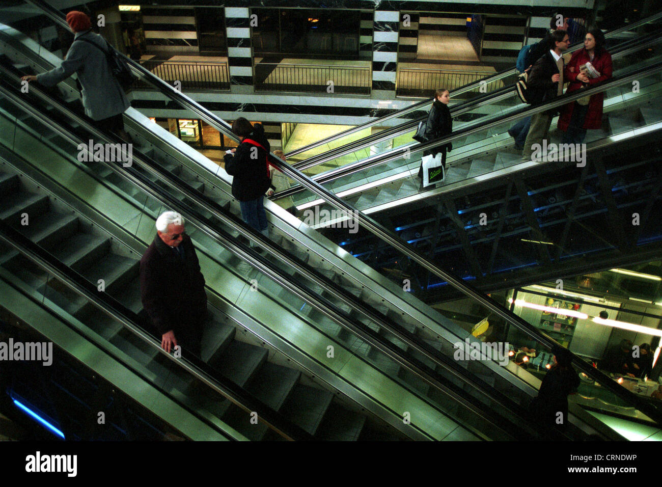 People on an escalator Stock Photo - Alamy