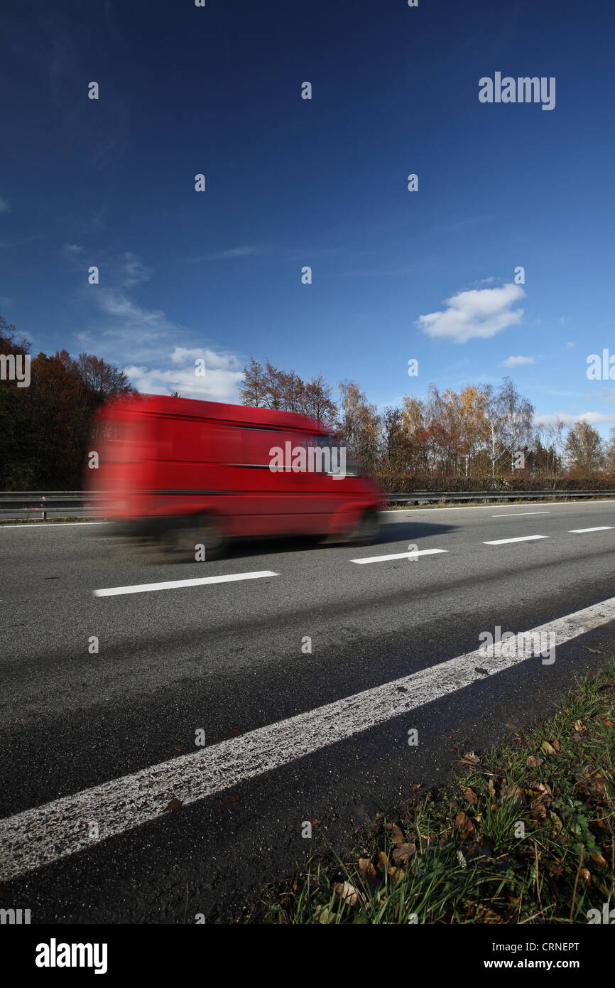 Red delivery/cargo van going fast on a highway Stock Photo - Alamy