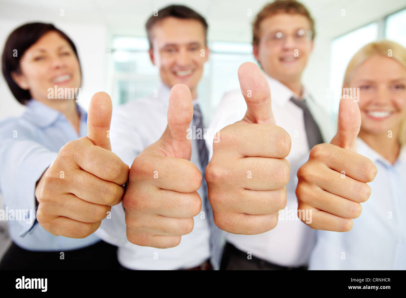 Cheerful business team holding their thumbs up with enthusiasm Stock ...