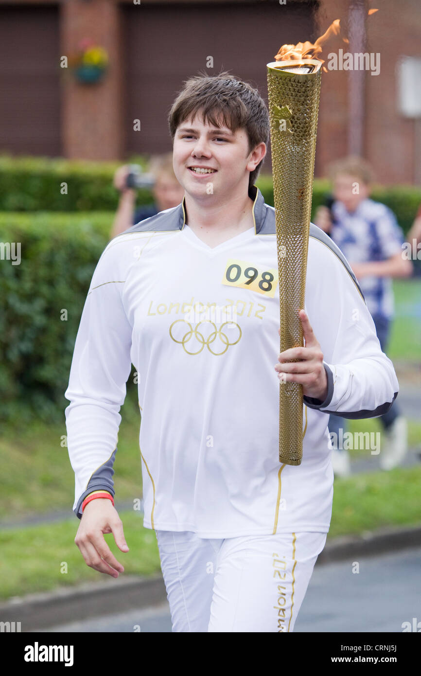 A runner with his London 2012 Olympic Torch during the torch relay ...
