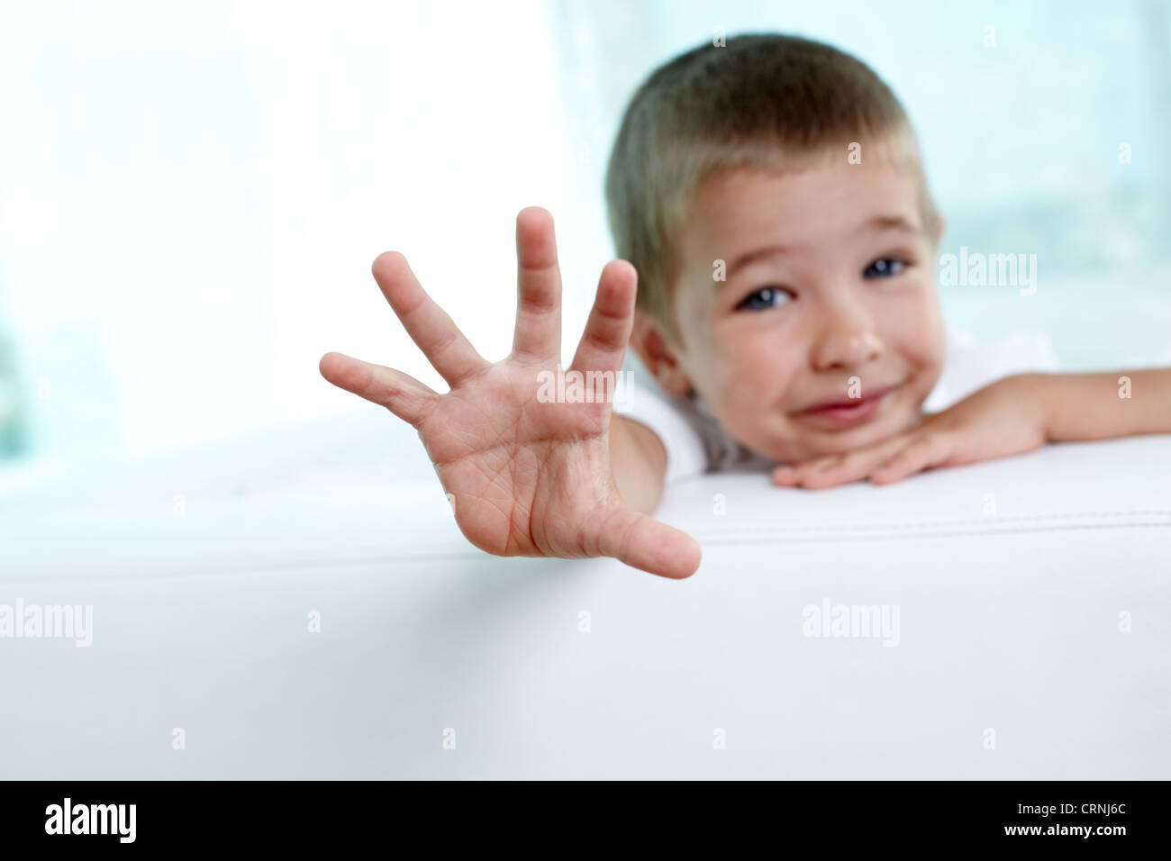 Little boy reaching out towards the camera Stock Photo - Alamy
