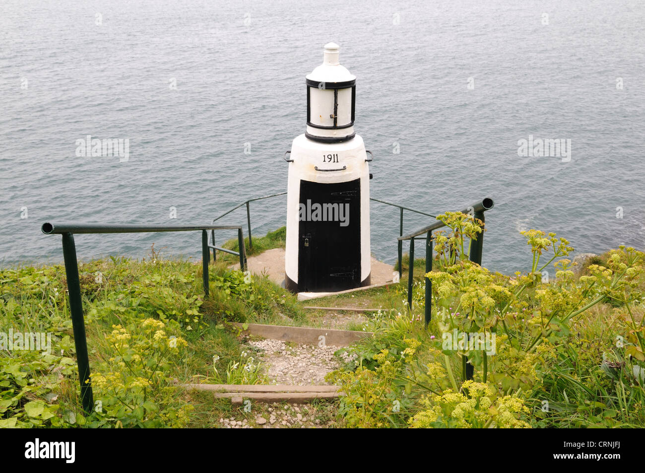 Polpero Lighthouse on a rocky coastline near Polperro Cornwall England ...