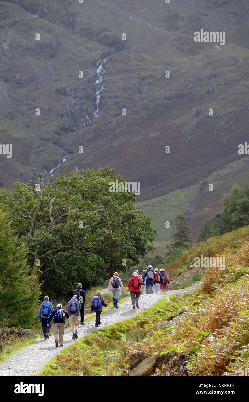 Ramblers walking along a path through Buttermere in the Lake District ...