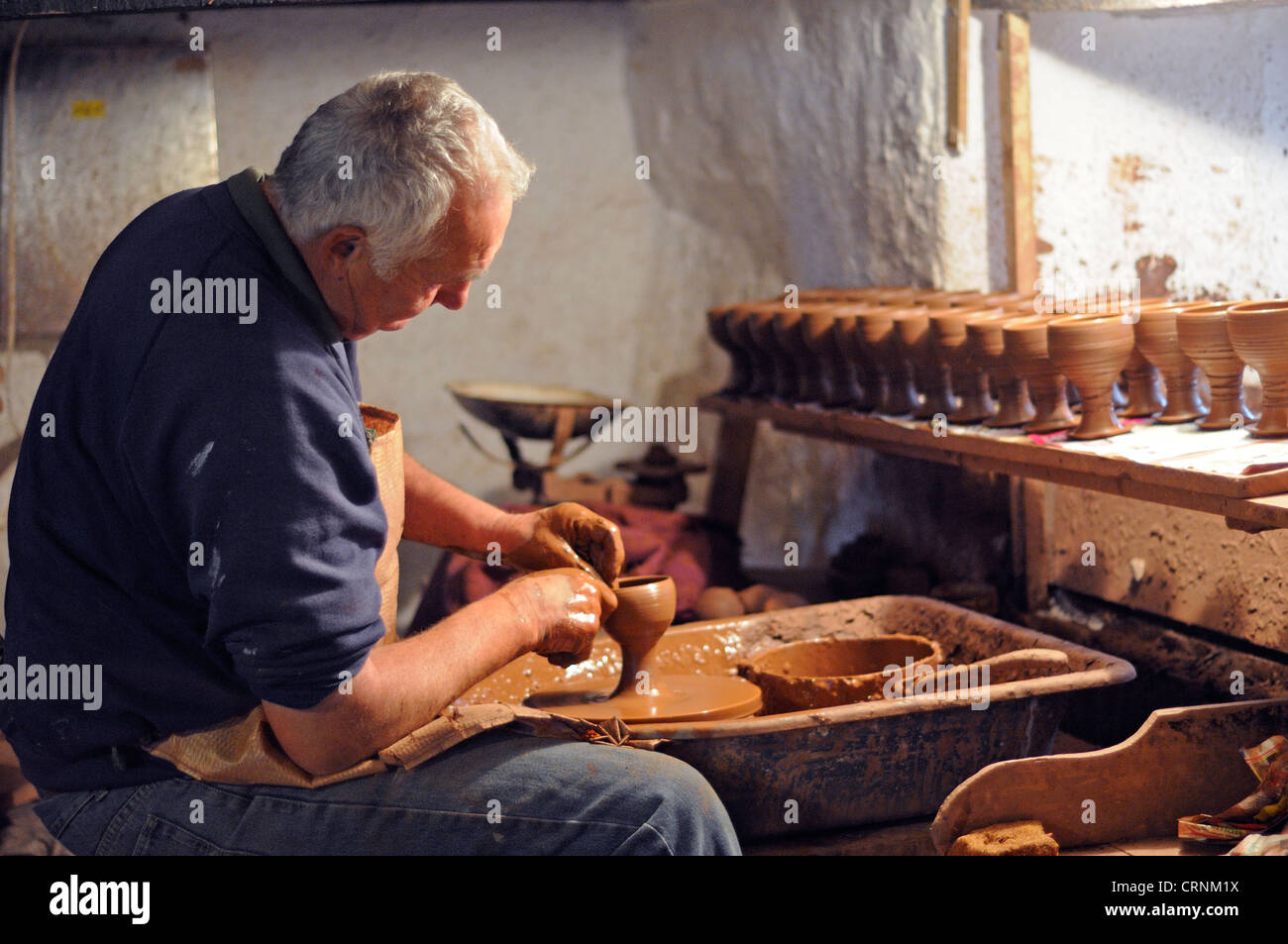 Potter turning traditional clay goblets Stock Photo - Alamy