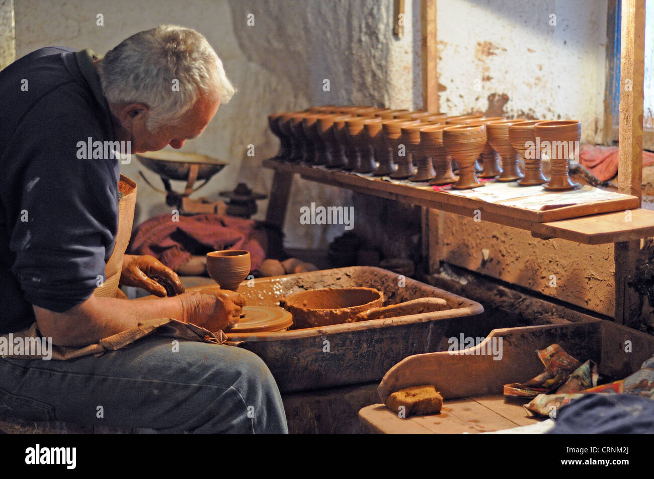 Potter turning traditional clay goblets Stock Photo - Alamy