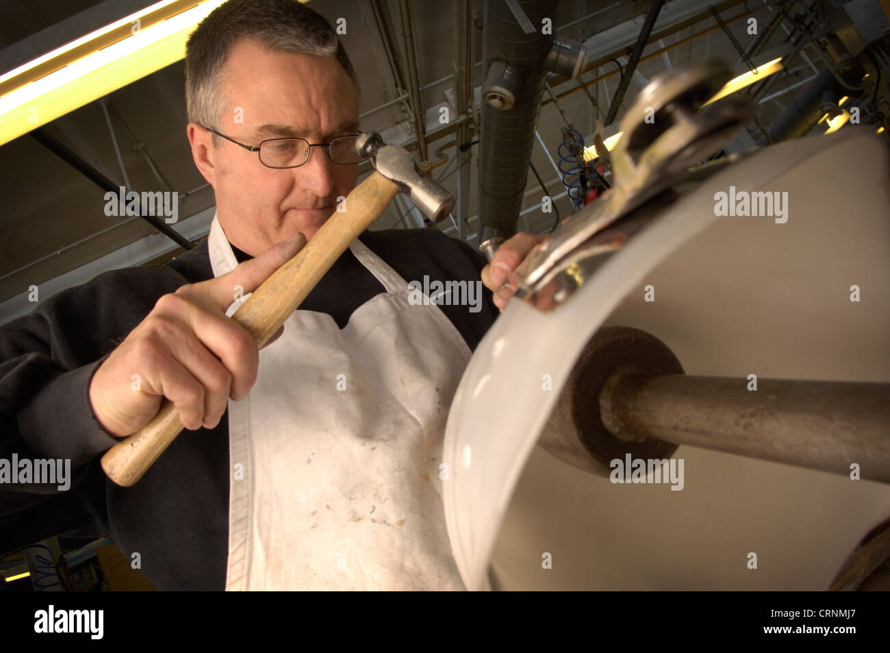 A prosthesis technician rivets a polypropylene socket to comfortably ...