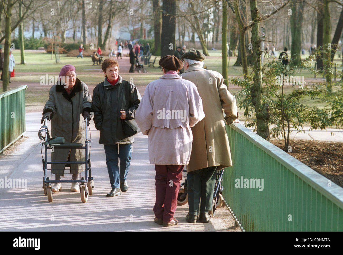 Encounter between elderly people in the park Stock Photo - Alamy