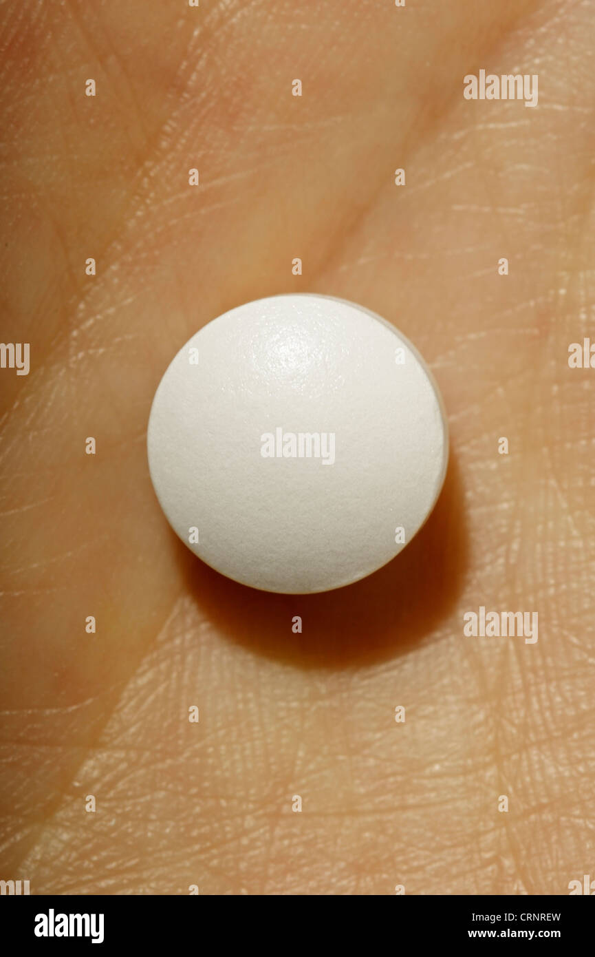 Single pill in hand Stock Photo - Alamy