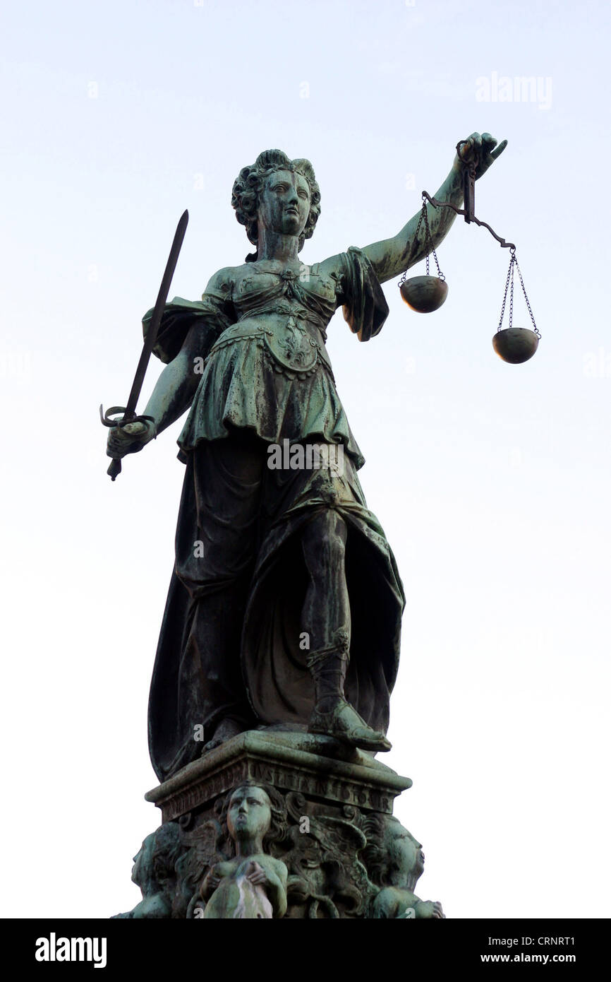 Justitia figure with scales and sword Stock Photo - Alamy
