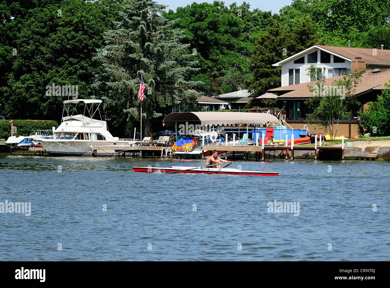 Man sculling (rowing) along shoreline on Illinois river Stock Photo - Alamy