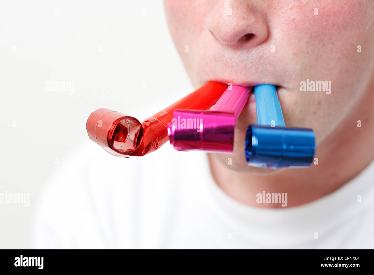 A person playing with party blowers Stock Photo - Alamy