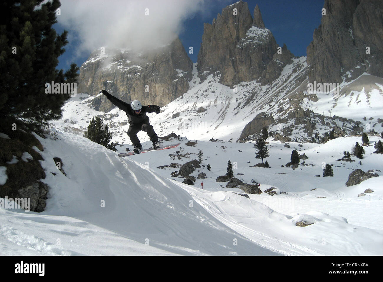 A freestyle snowboarder jumping in the alps Stock Photo - Alamy