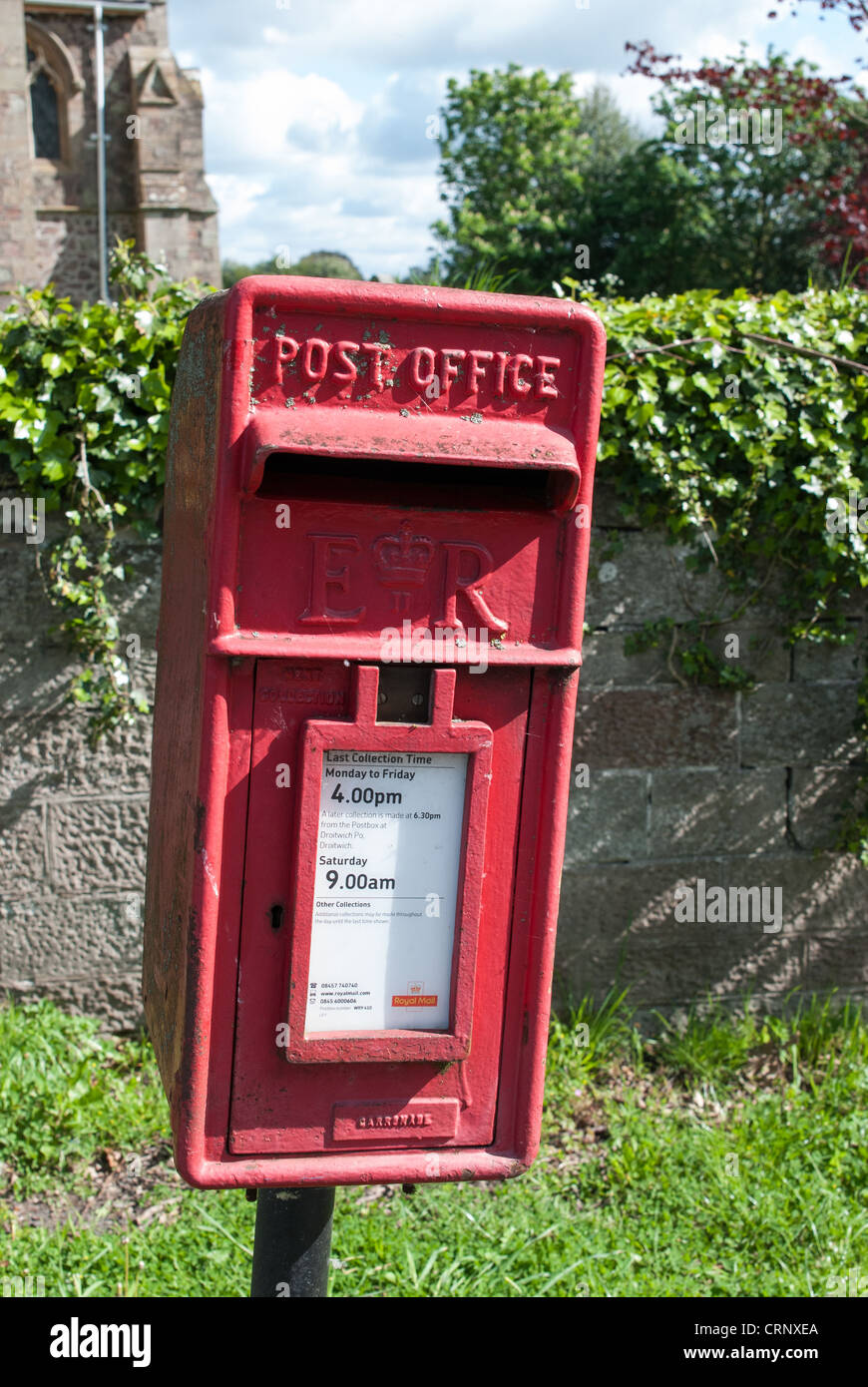 Small red stand-mounted post box in the worcestershire village of Stoke ...