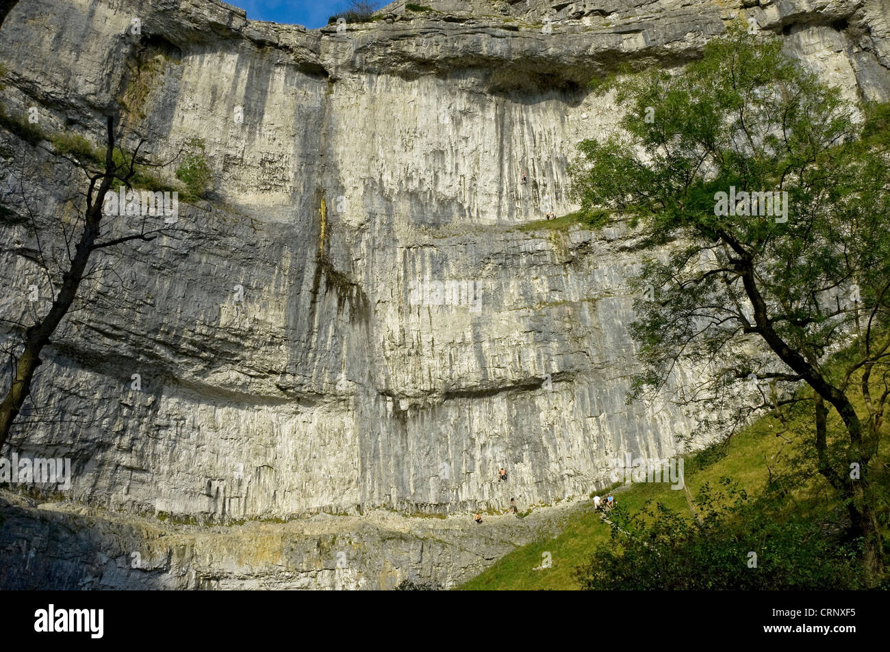 People rock climbing on Malham Cove, a spectacular limestone crag ...