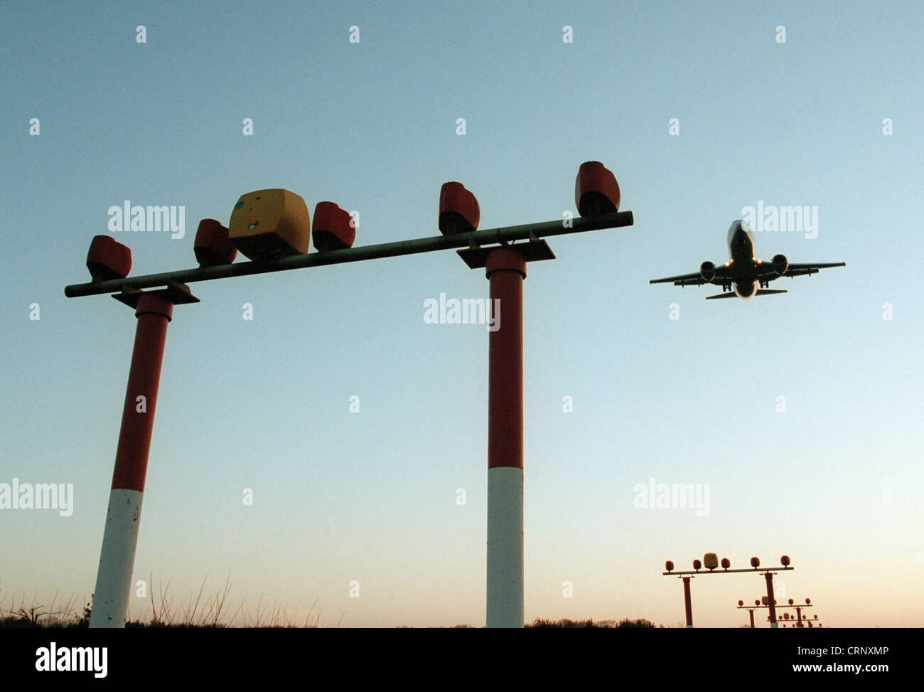 Approach lights and airplane landing at night Stock Photo - Alamy