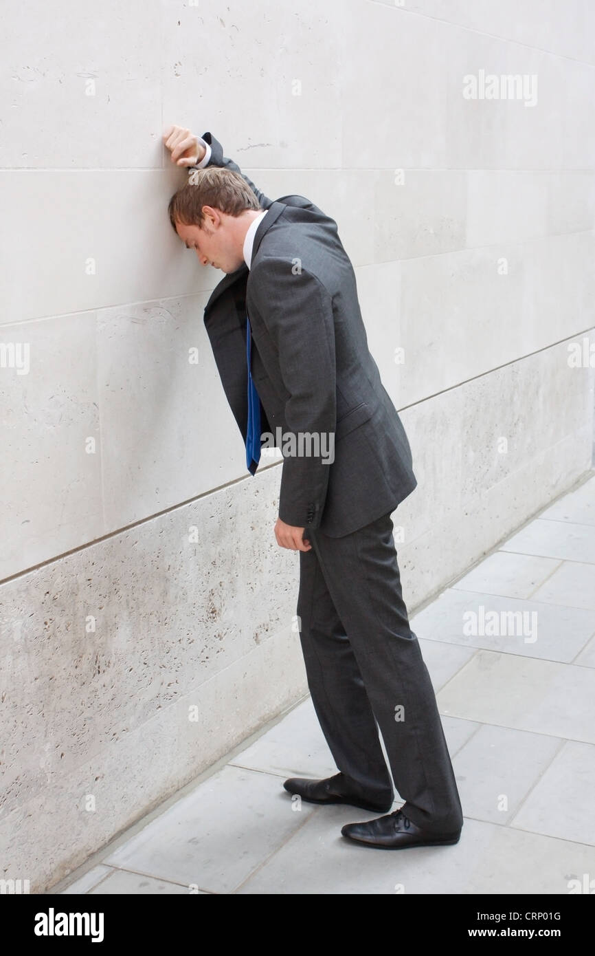 Homeless man sitting against wall hi-res stock photography and images ...