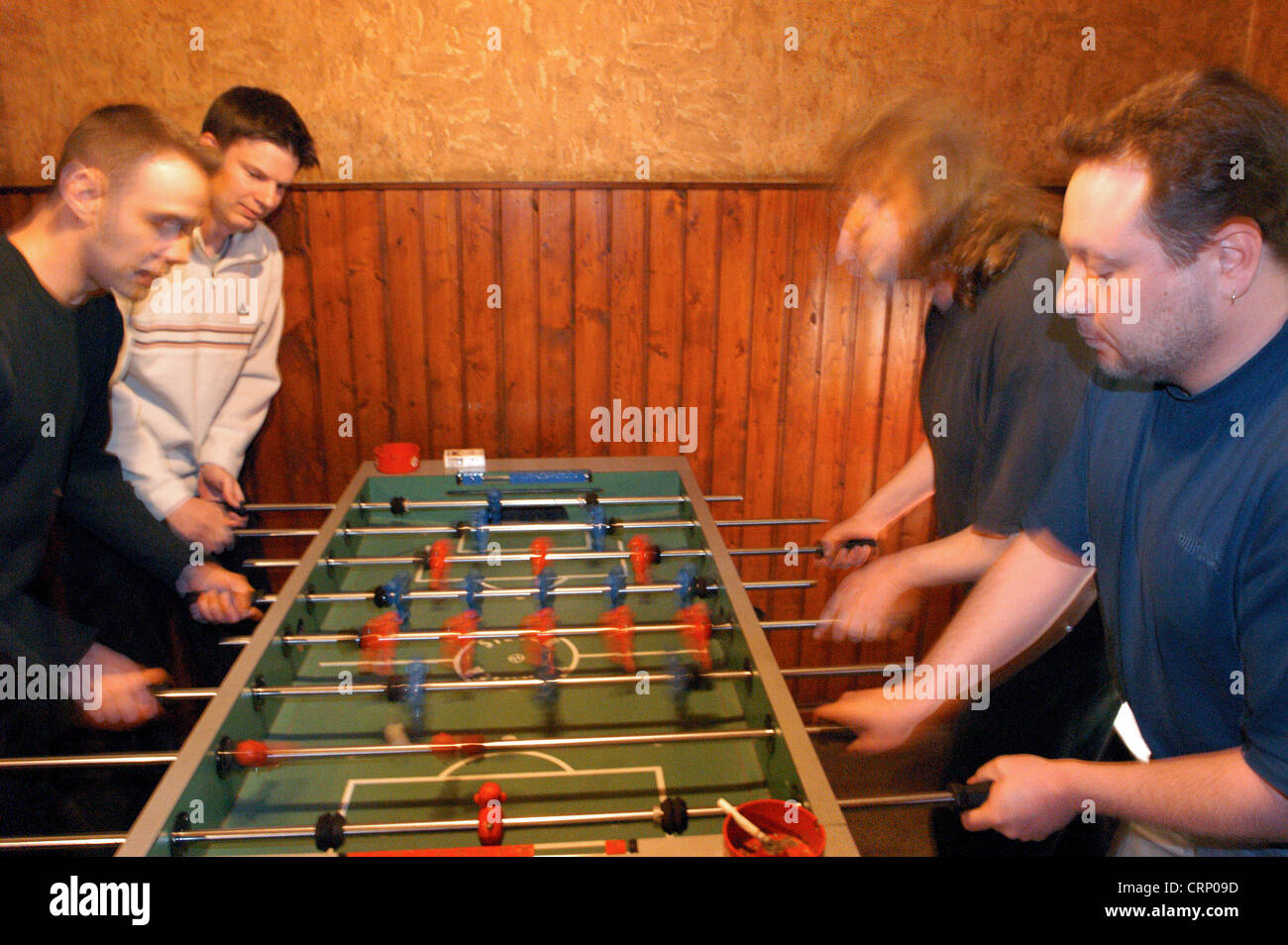 Four men at table football Stock Photo - Alamy