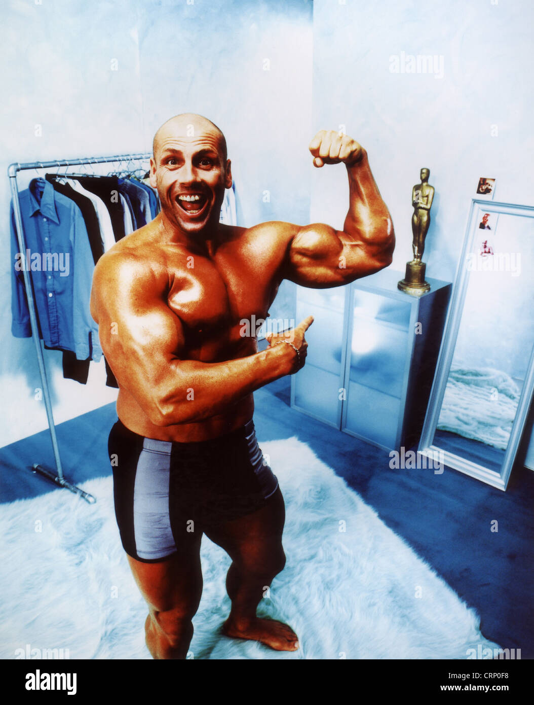 Muscle man presents his biceps Stock Photo - Alamy