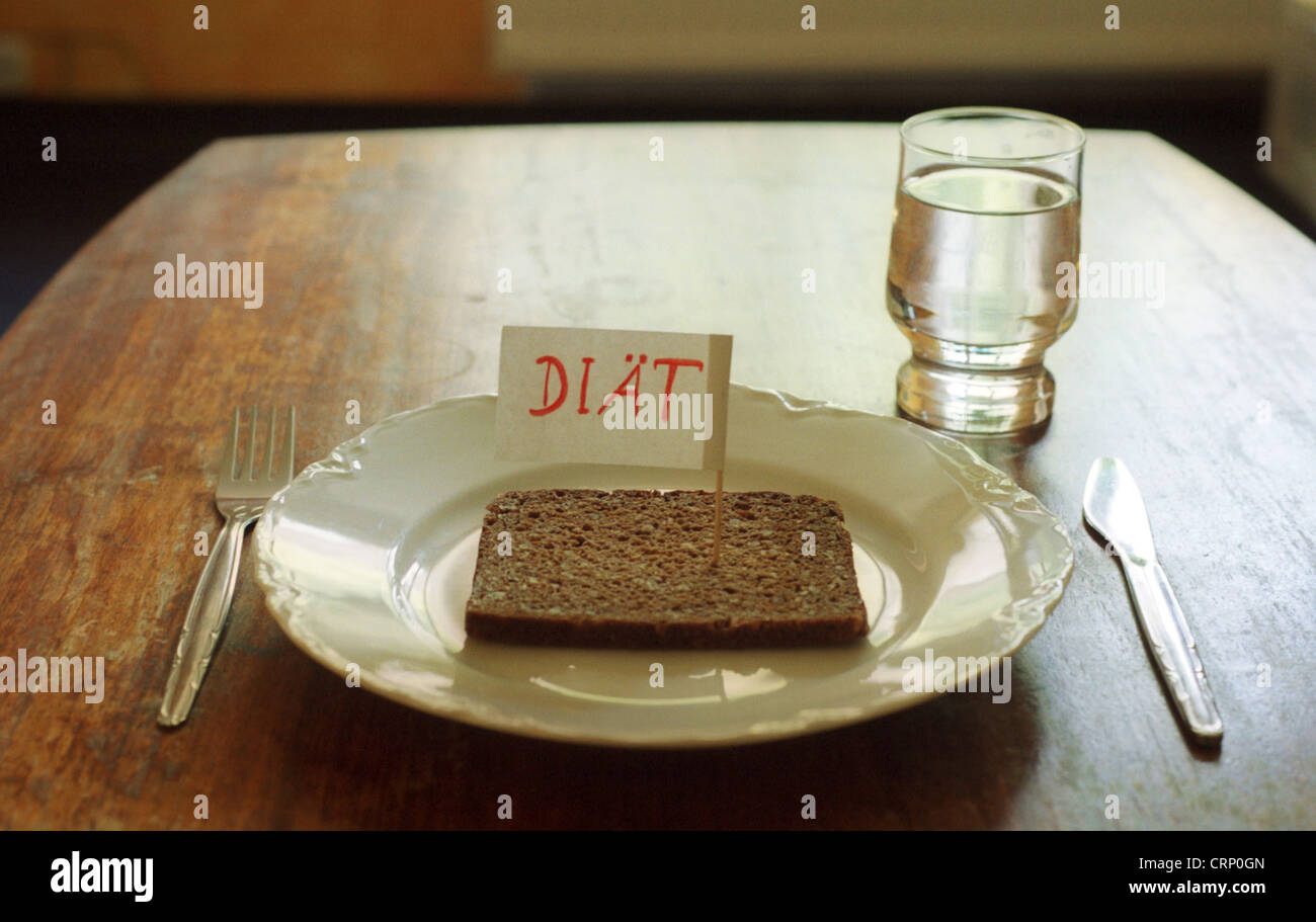 A sign and a slice of bread on a plate Stock Photo - Alamy