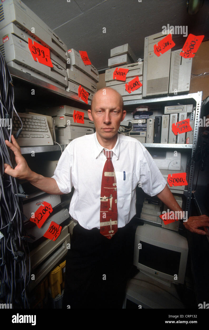 Seller is faced with a shelf of used computers Stock Photo - Alamy
