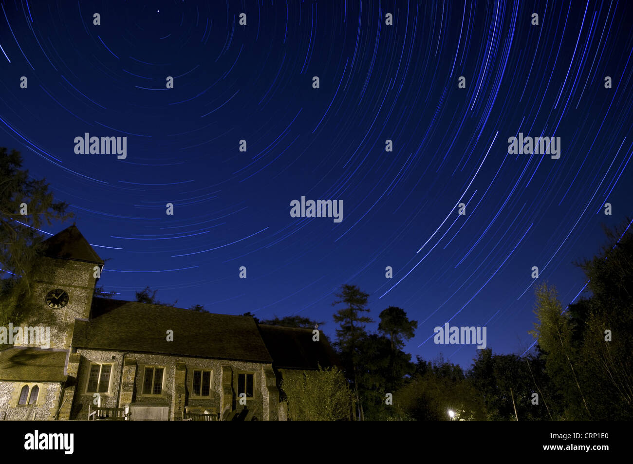 Stars revolving around Polaris (Pole Star) over church at night ...
