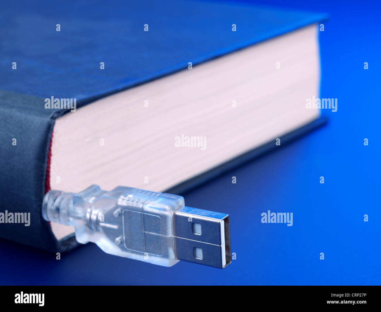 Book with USB connection. Blue background Stock Photo - Alamy