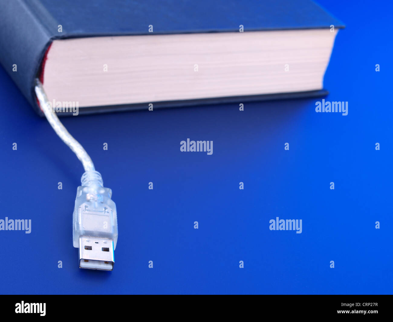 Book with USB connection. Blue background Stock Photo - Alamy