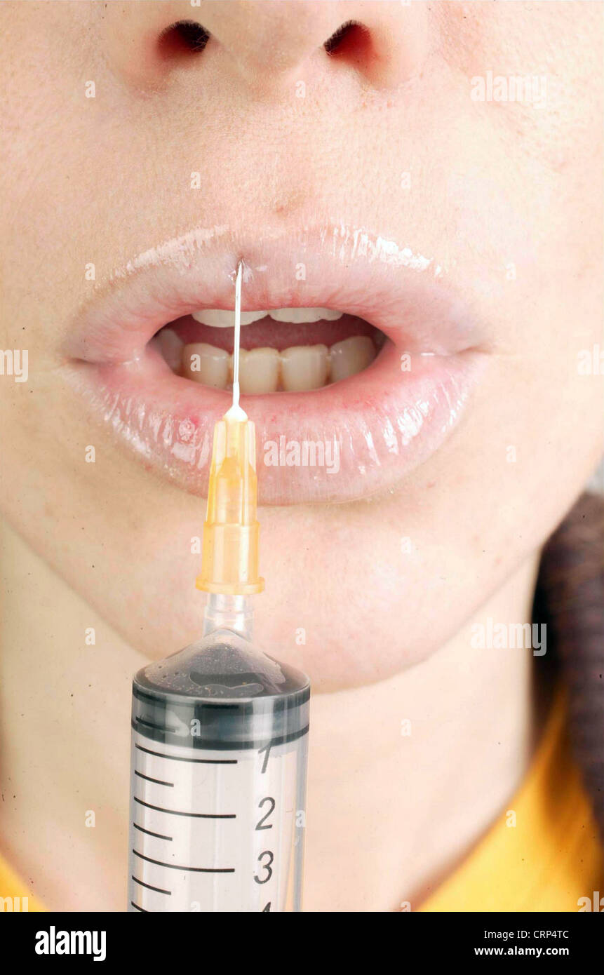 Woman with syringe Stock Photo - Alamy