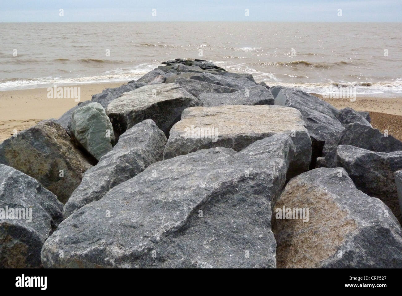 Granite rock groynes protect the beach at Felixstowe Suffolk from ...
