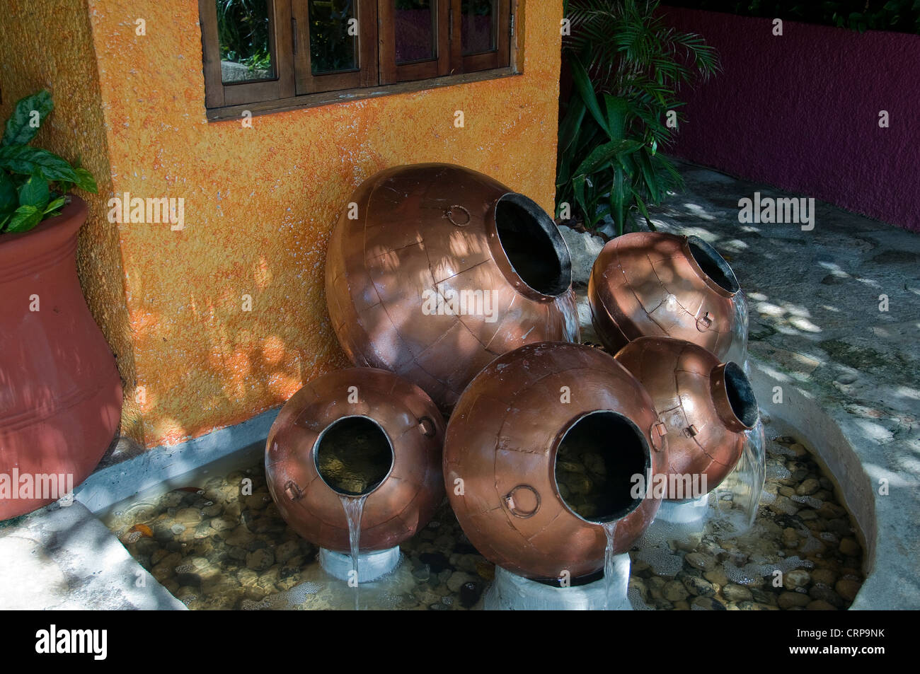 A handful of copper pots pouring waters at the Xel-Ha attraction in ...