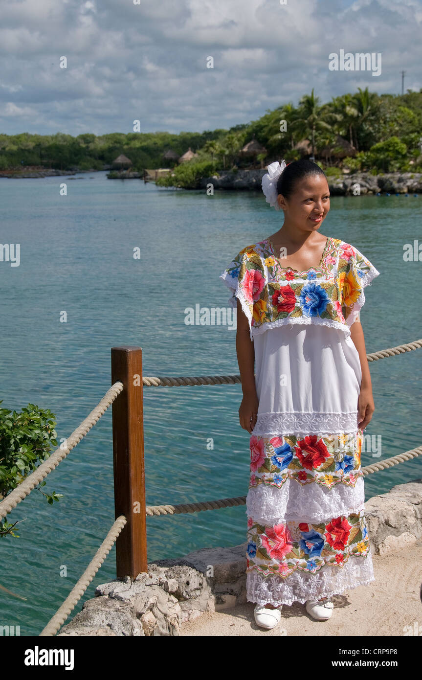 A pretty Maya lady stands in front of the crystal clear, spring-fed ...