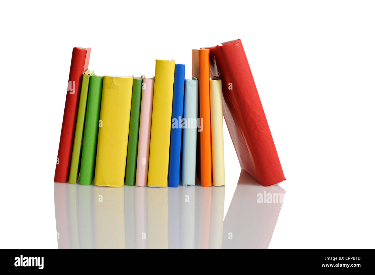 colored books in a row. Isolated on white background Stock Photo - Alamy