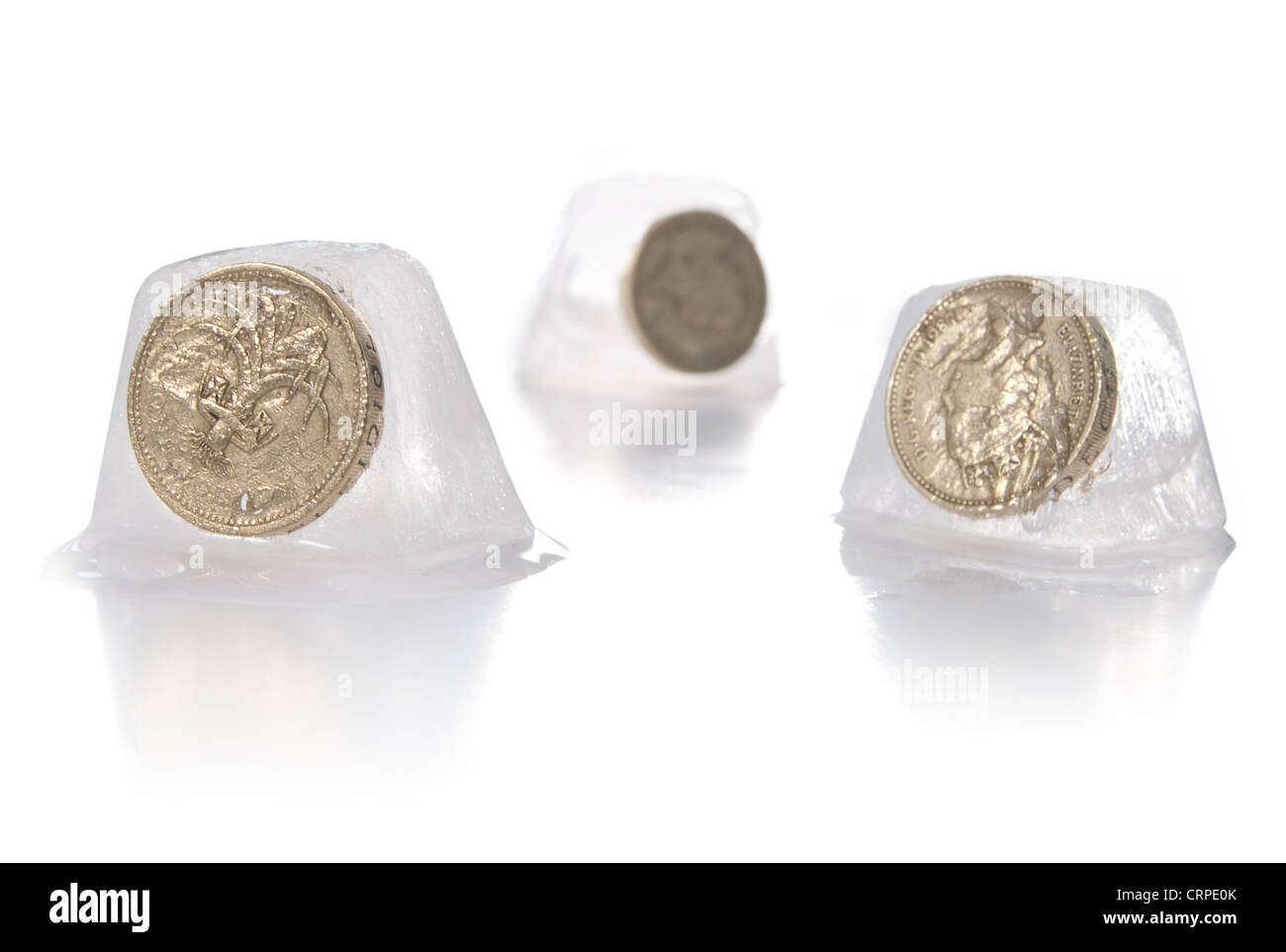 Frozen assets, pound coins inside ice cubes Stock Photo - Alamy