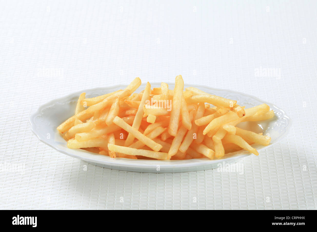 Portion of French fries in a plate Stock Photo - Alamy
